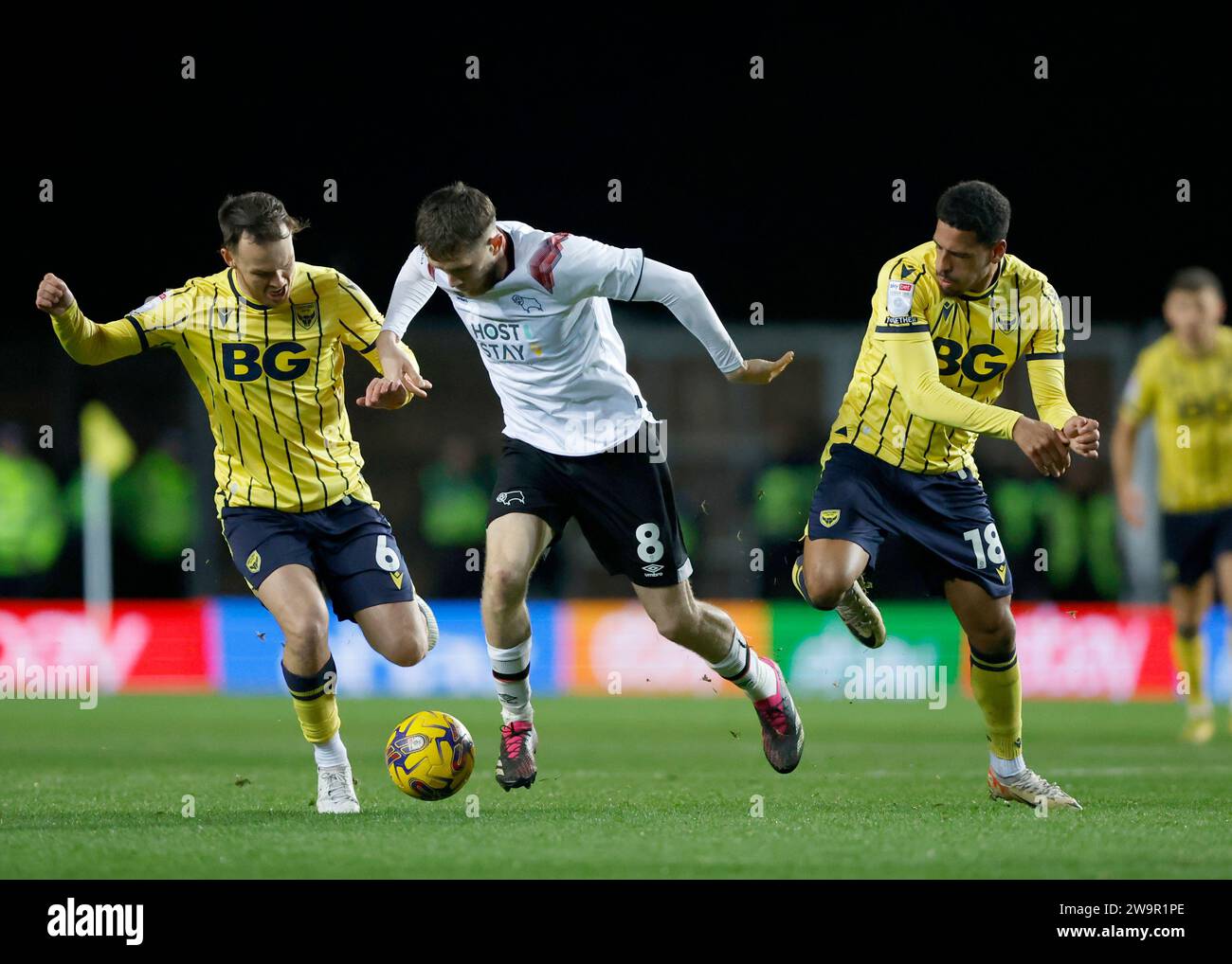 Derby County's Max Bird (centre) battle for the ball with Oxford United ...