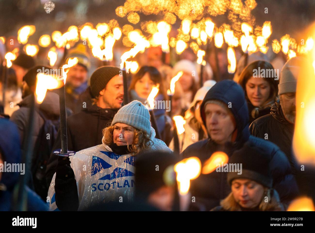 People during the torchlight procession in Edinburgh city centre, led ...