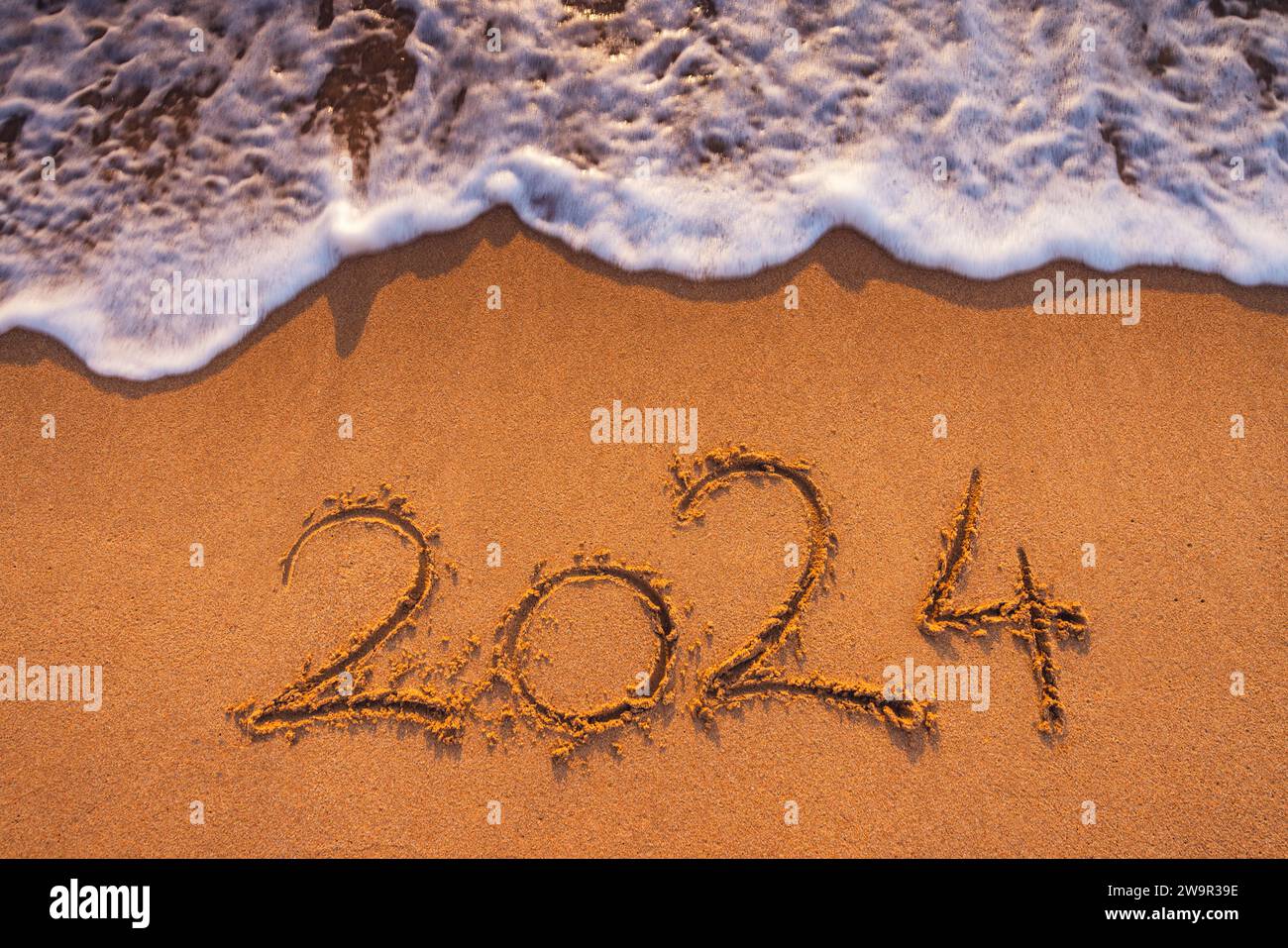 Happy New Year 2024 concept, lettering on the beach. Written text on ...