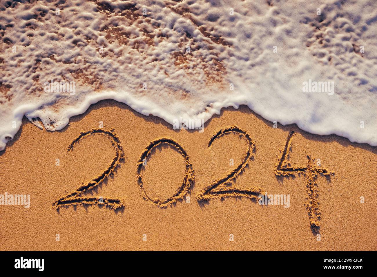 Happy New Year 2024 concept, lettering on the beach. Written text on ...