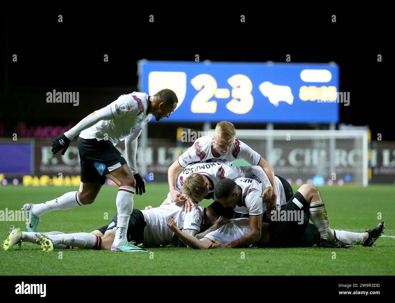 Derby County's Eiran Cashin (obscured) is mobbed by his team mates ...