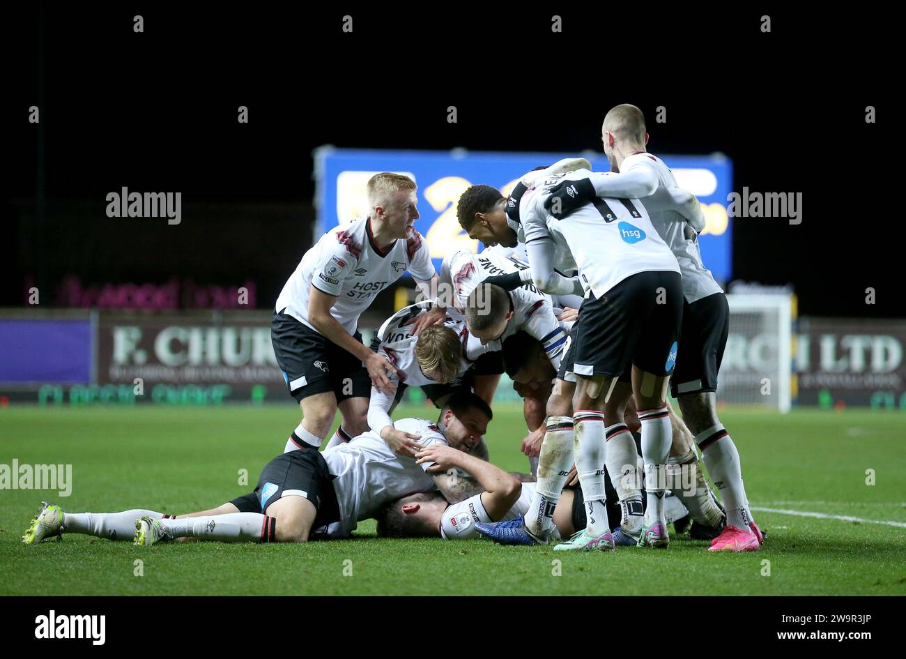 Derby County's Eiran Cashin (obscured) is mobbed by his team mates ...