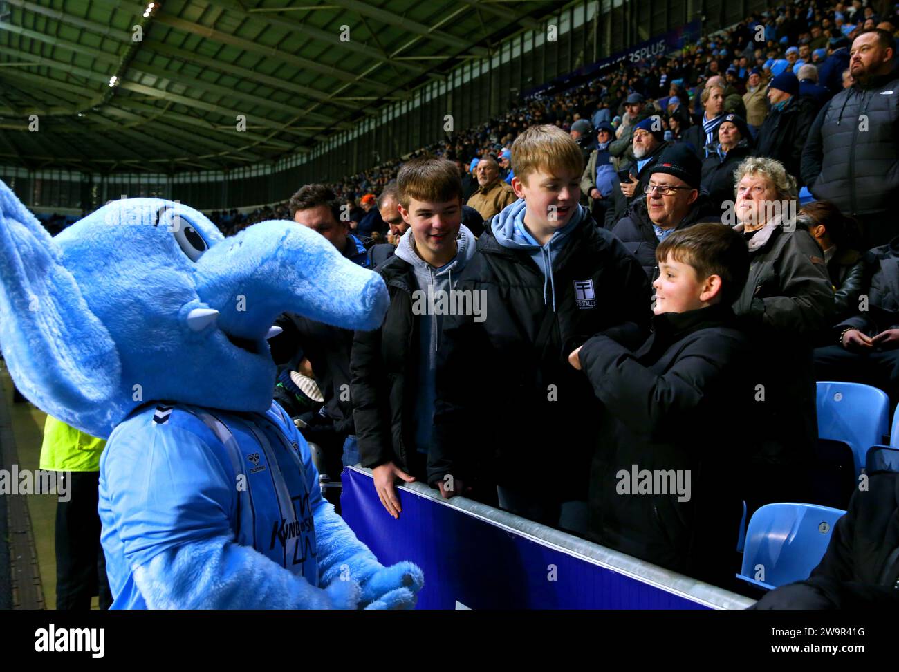 Coventry City mascot Sky Blue Sam poses for a photo with a fan in the ...