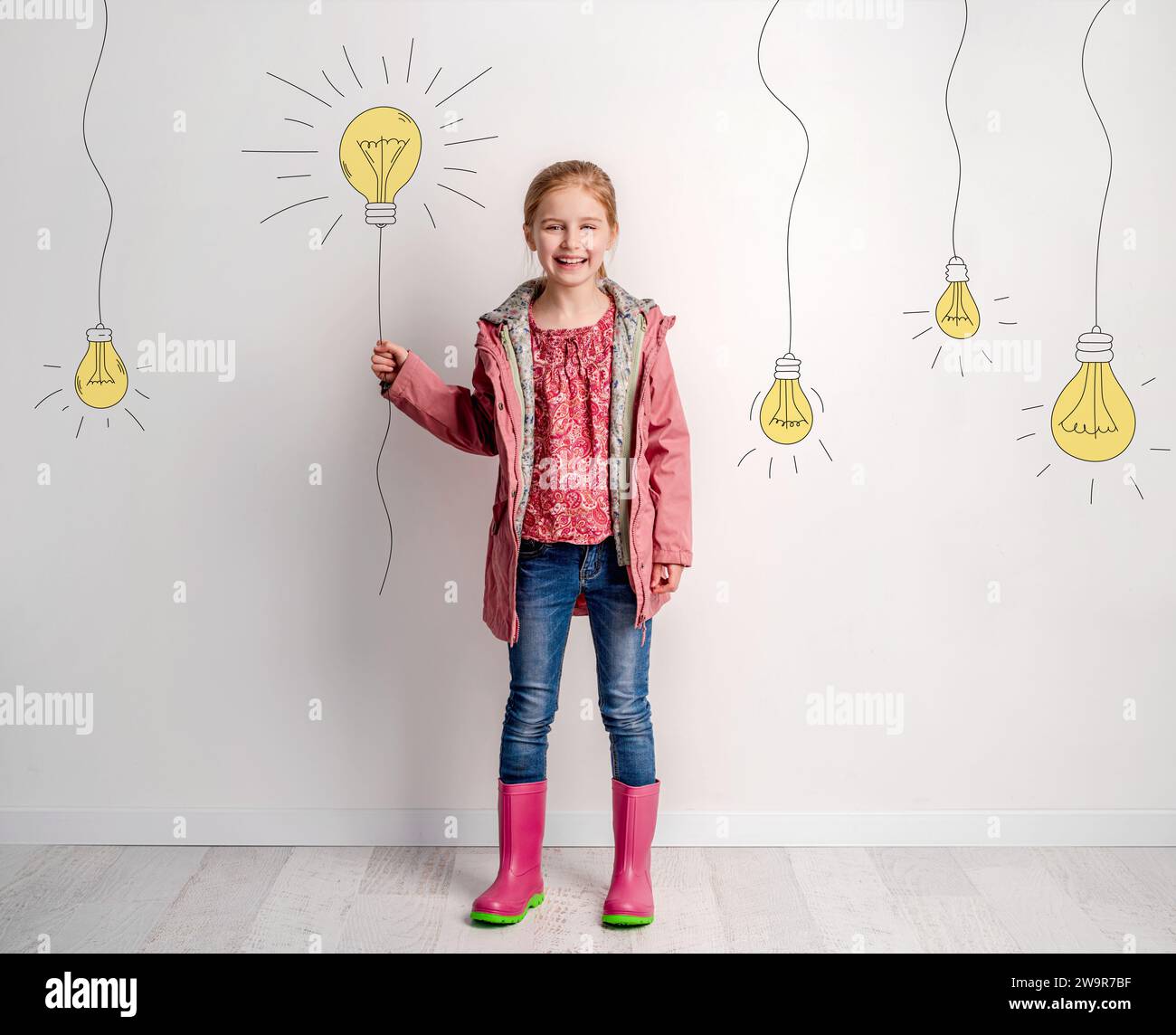 Girl Turns On Painted Wall Light Bulb, Symbolizing Child Invention And ...