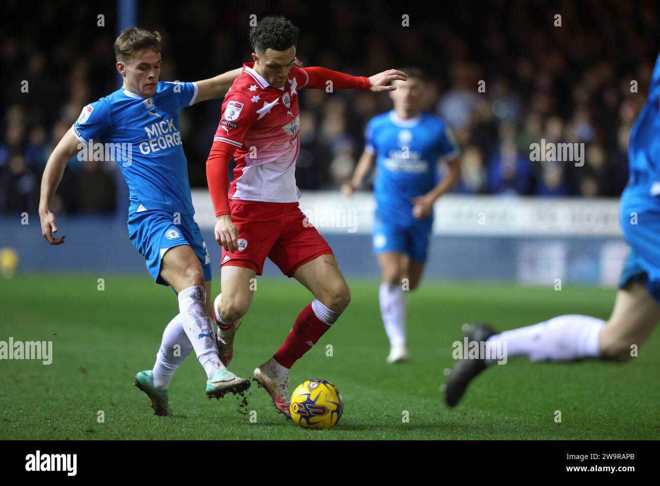 Peterborough, UK. 29th Dec, 2023. Archie Collins (PU) Jordan Williams ...