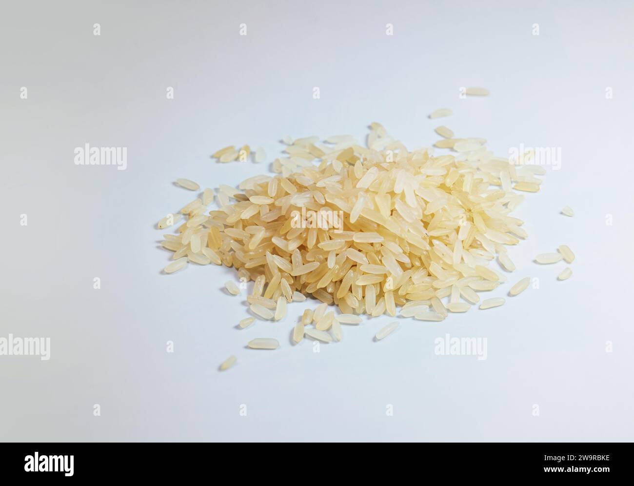 Small heap of uncooked parboiled rice, also called converted rice, on a ...