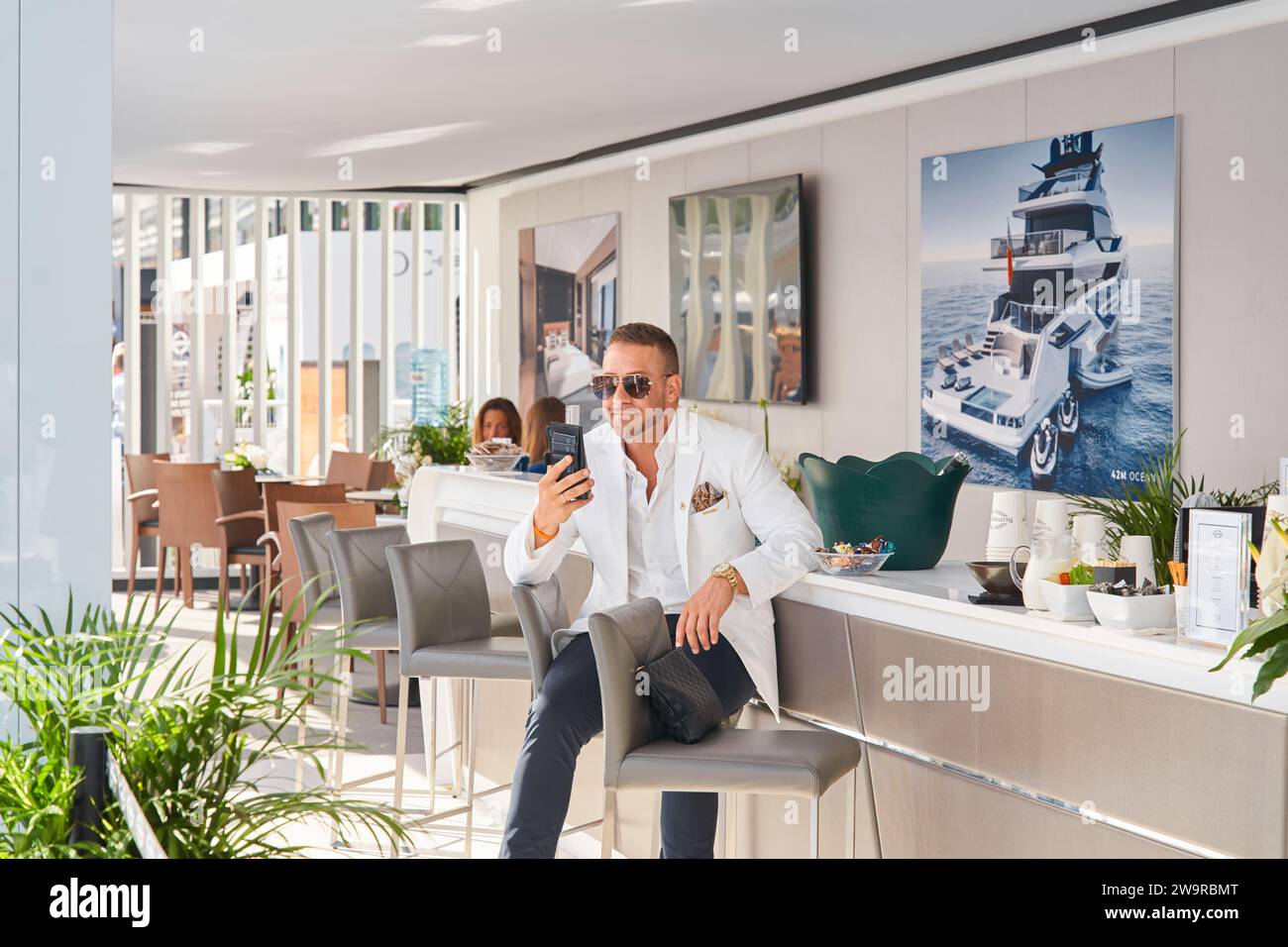 Monaco, Monte Carlo, 29 September 2022 - a handsome stylish man sits on ...