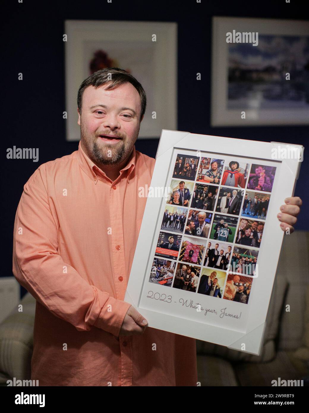 Actor James Martin holds a framed photo of memorable moments in his ...