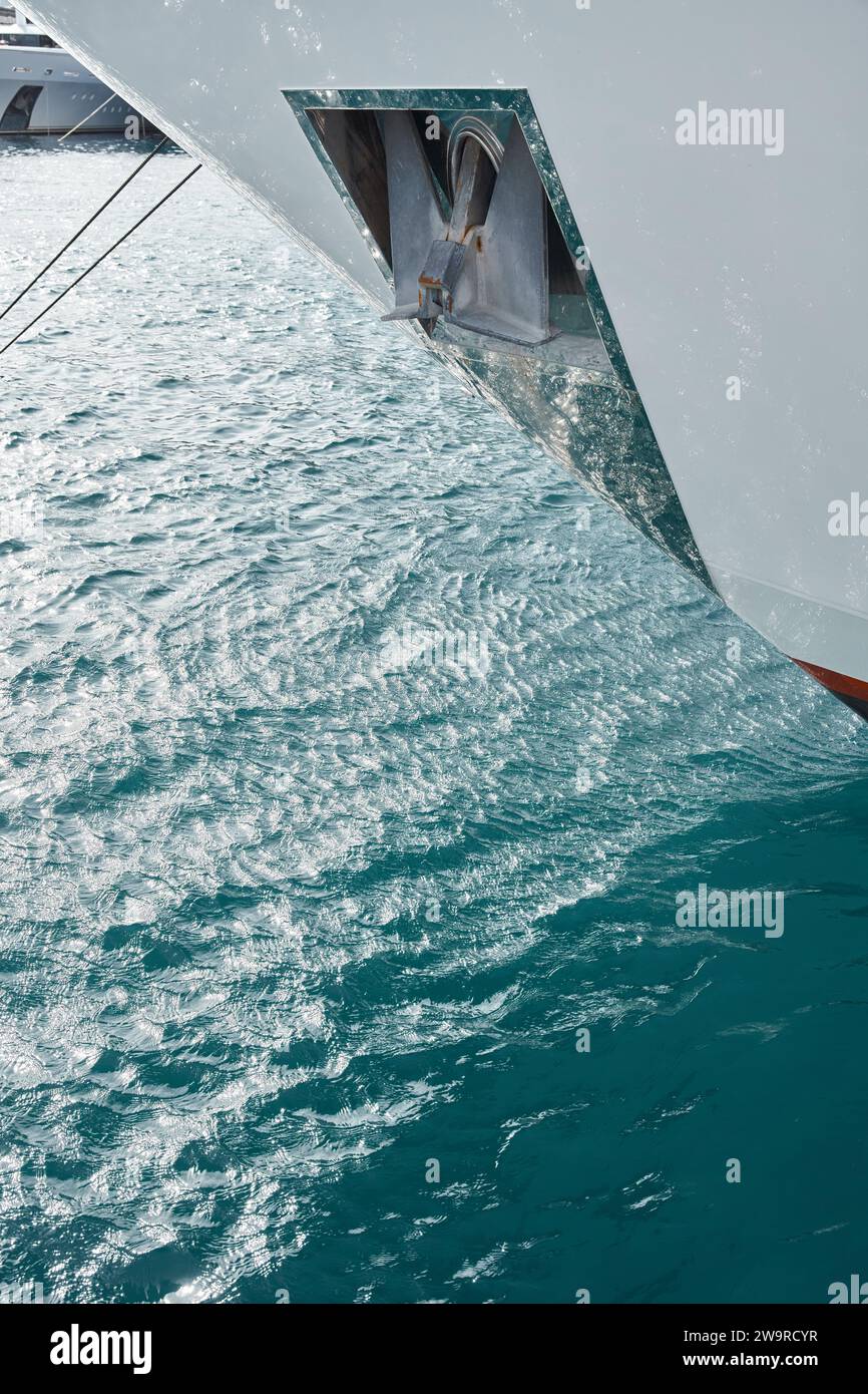Sun glare on glossy board of mega yacht, anchor, tranquillity in port ...