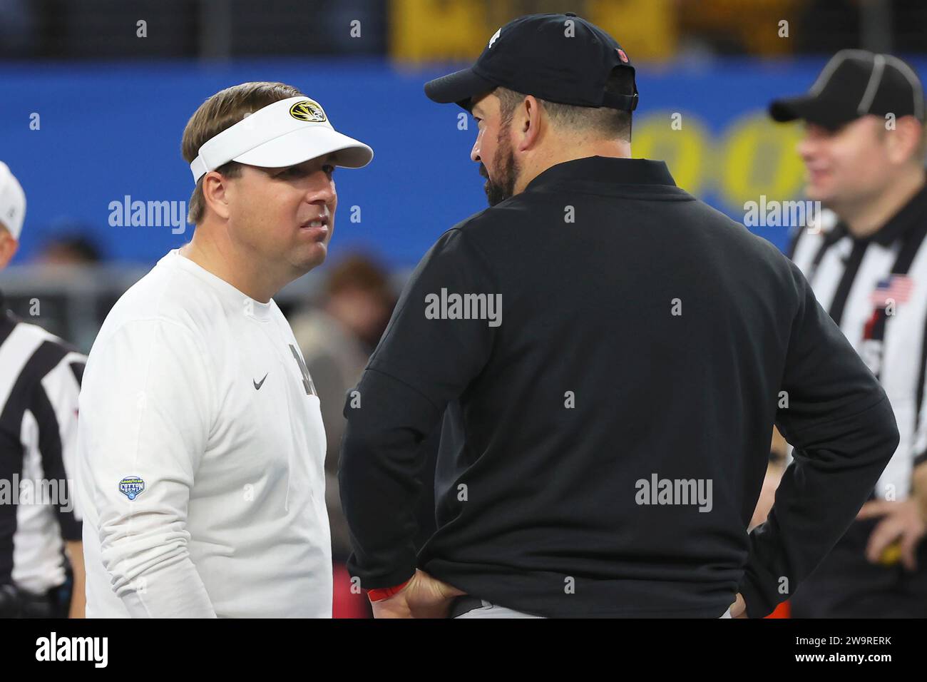 Missouri coach Eliah Drinkwitz, left, talks with Ohio State coach Ryan ...