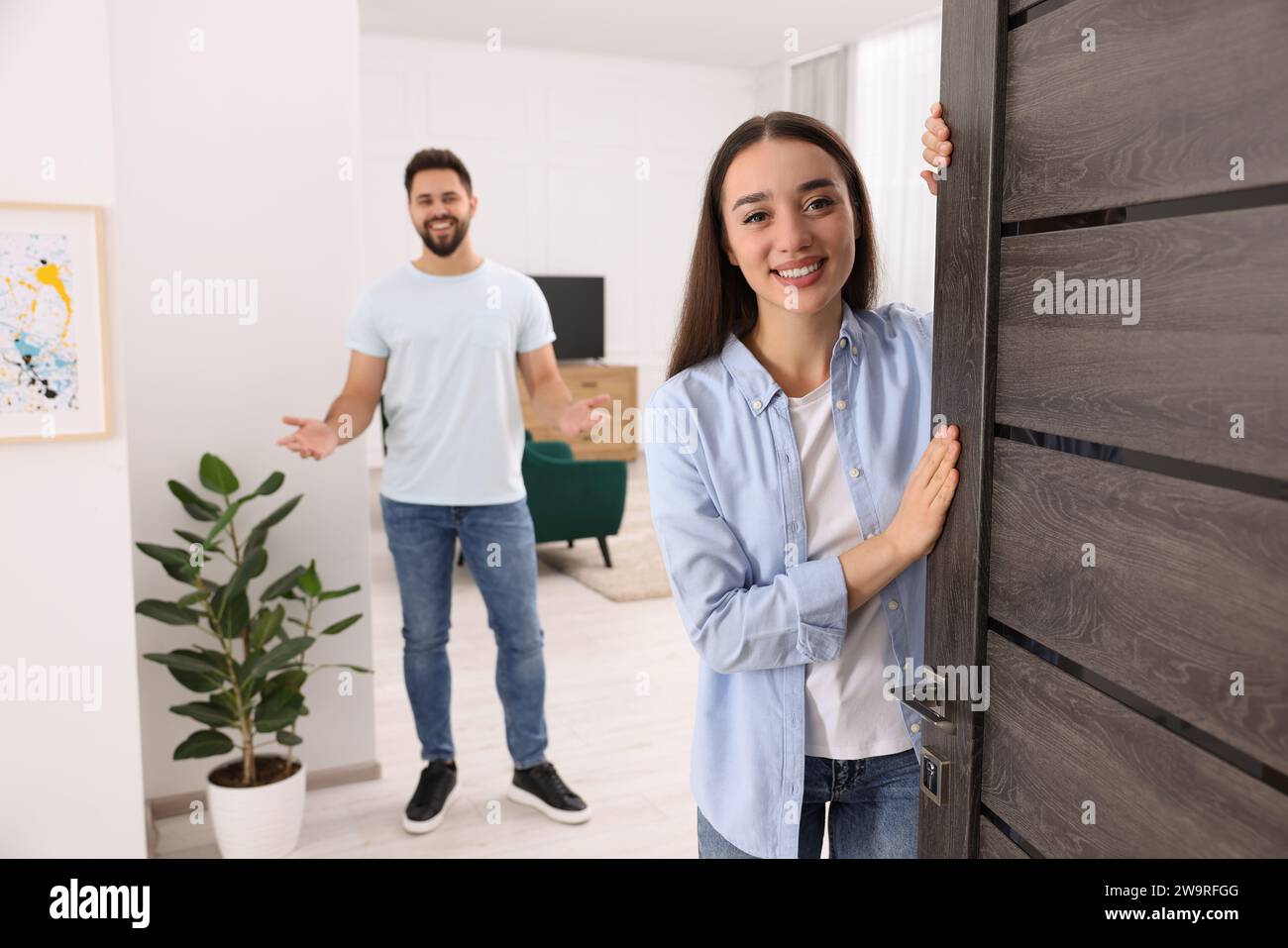Welcoming guest into home hi-res stock photography and images - Alamy
