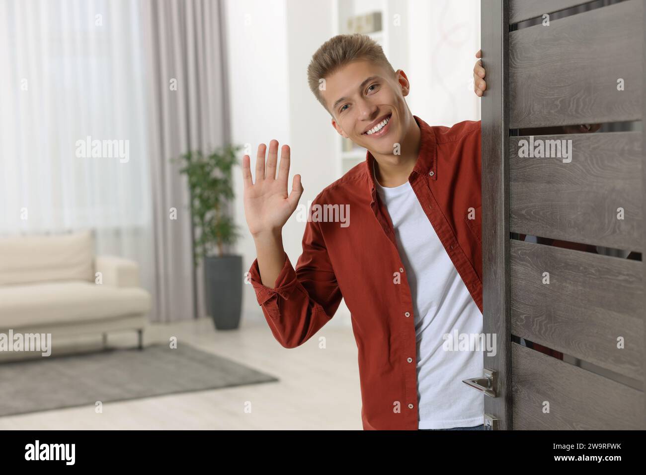 Hello welcoming young man waving hi-res stock photography and images ...
