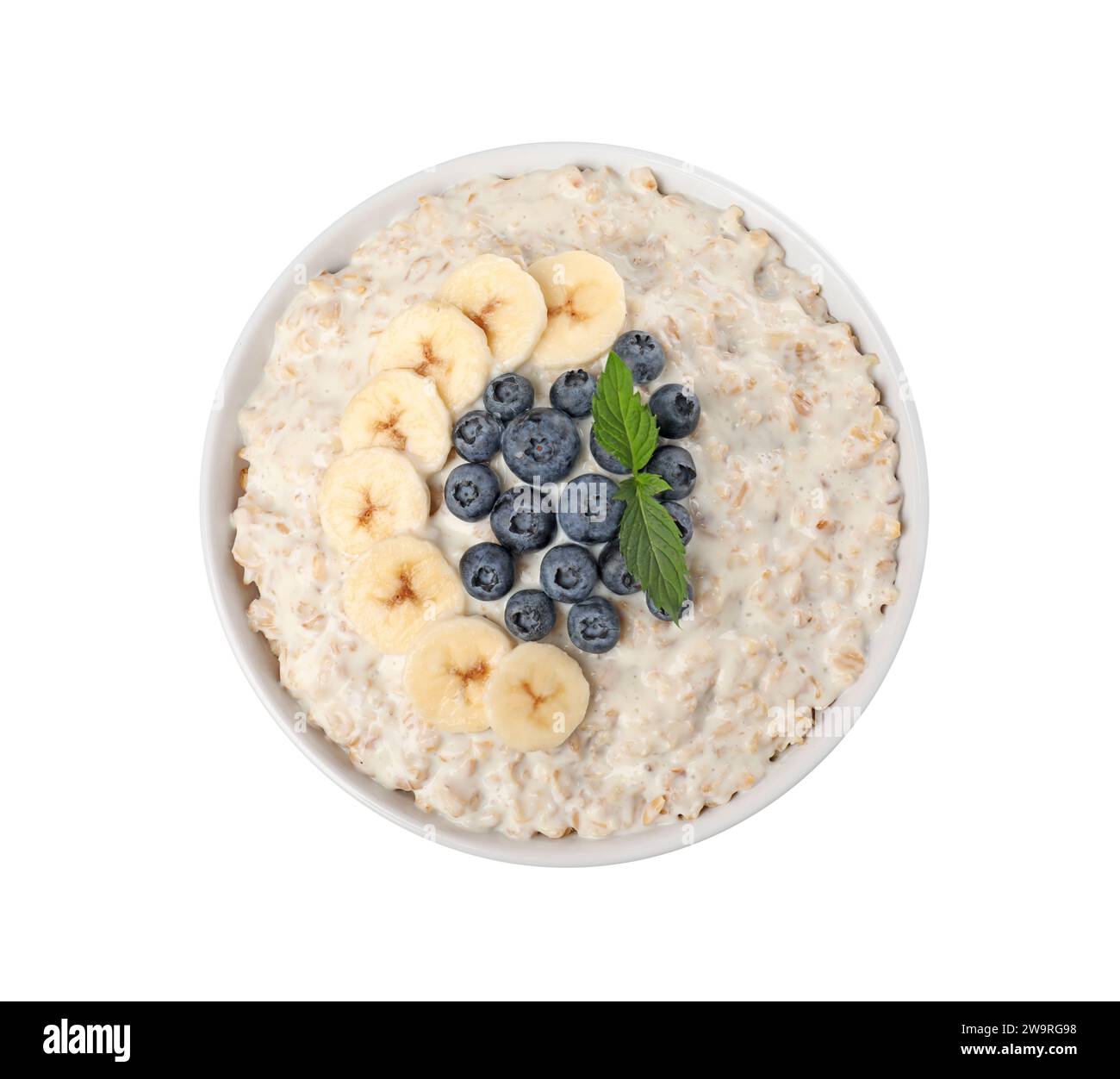 Tasty boiled oatmeal with banana and blueberries in bowl isolated on ...