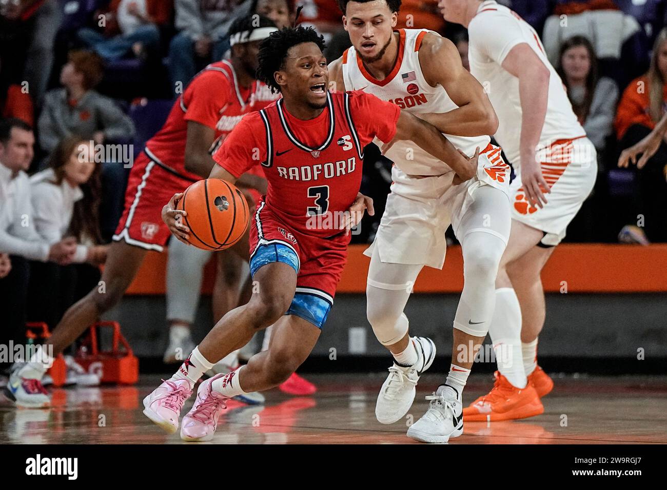 Radford guard Kenyon Giles (3) works against Clemson guard Chase Hunter ...