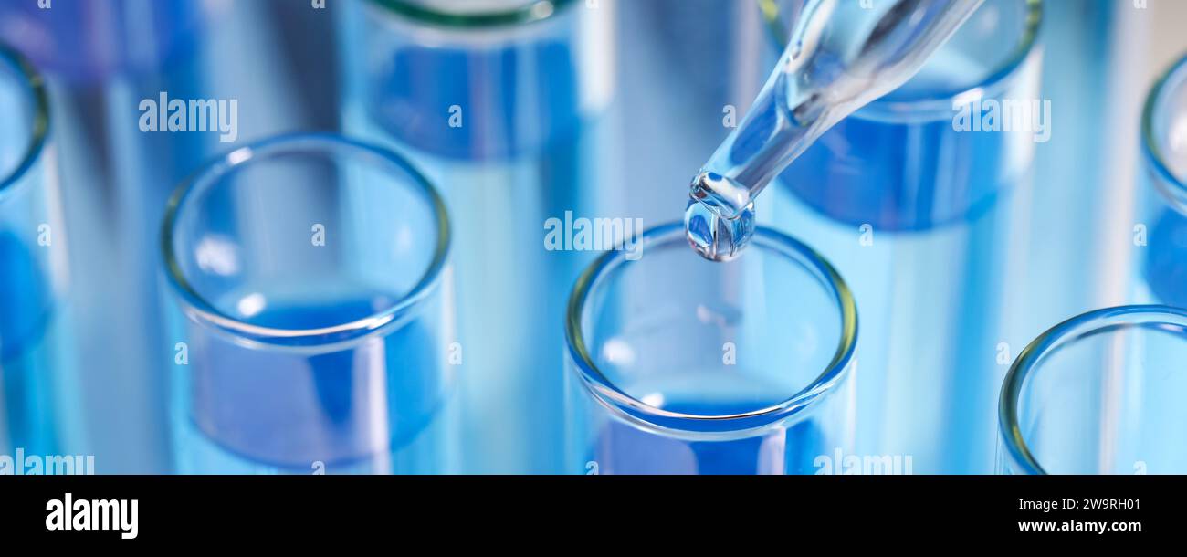 Laboratory analysis. Dripping reagent into test tube, closeup. Banner ...
