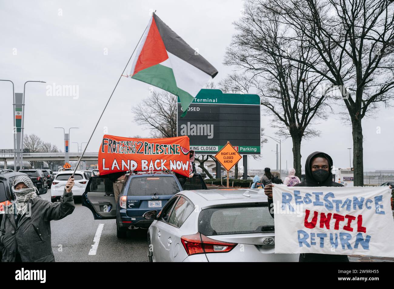 New York City, United States. 27th Dec, 2023. Protesters hold banners ...