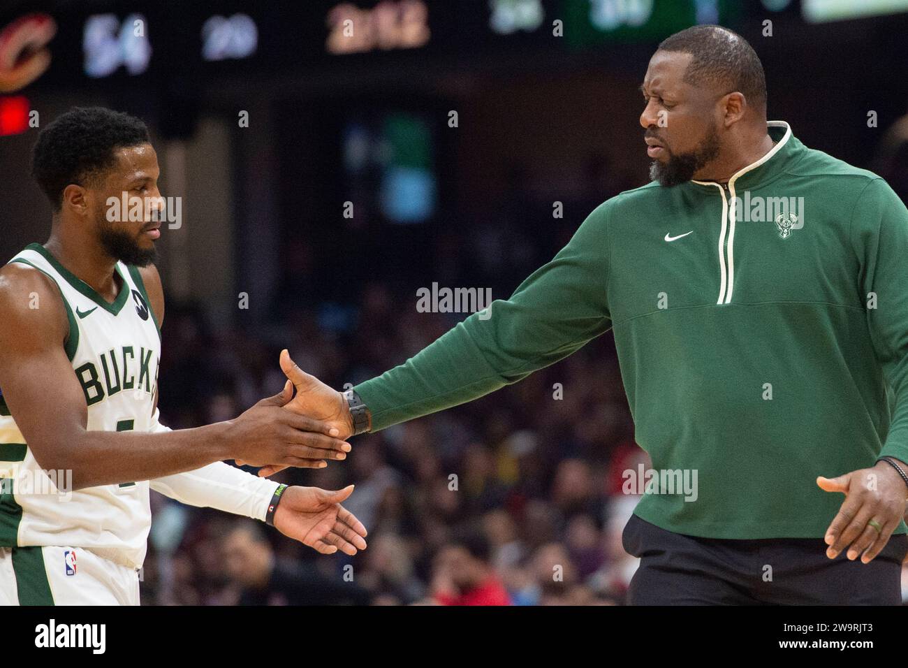 Milwaukee Bucks head coach Adrian Griffin, right, congratulates Malik ...