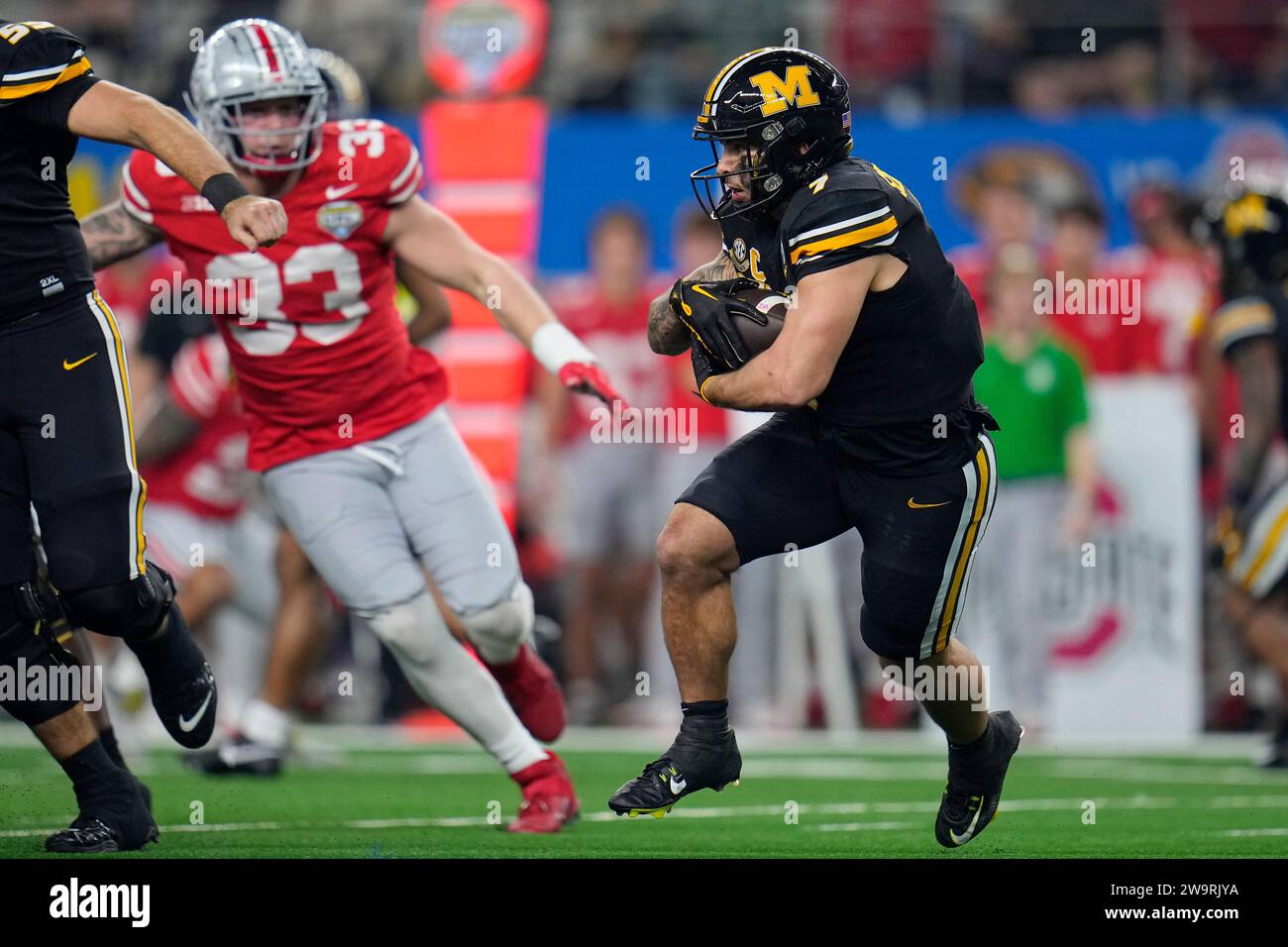 Missouri running back Cody Schrader, right, runs against Ohio State ...