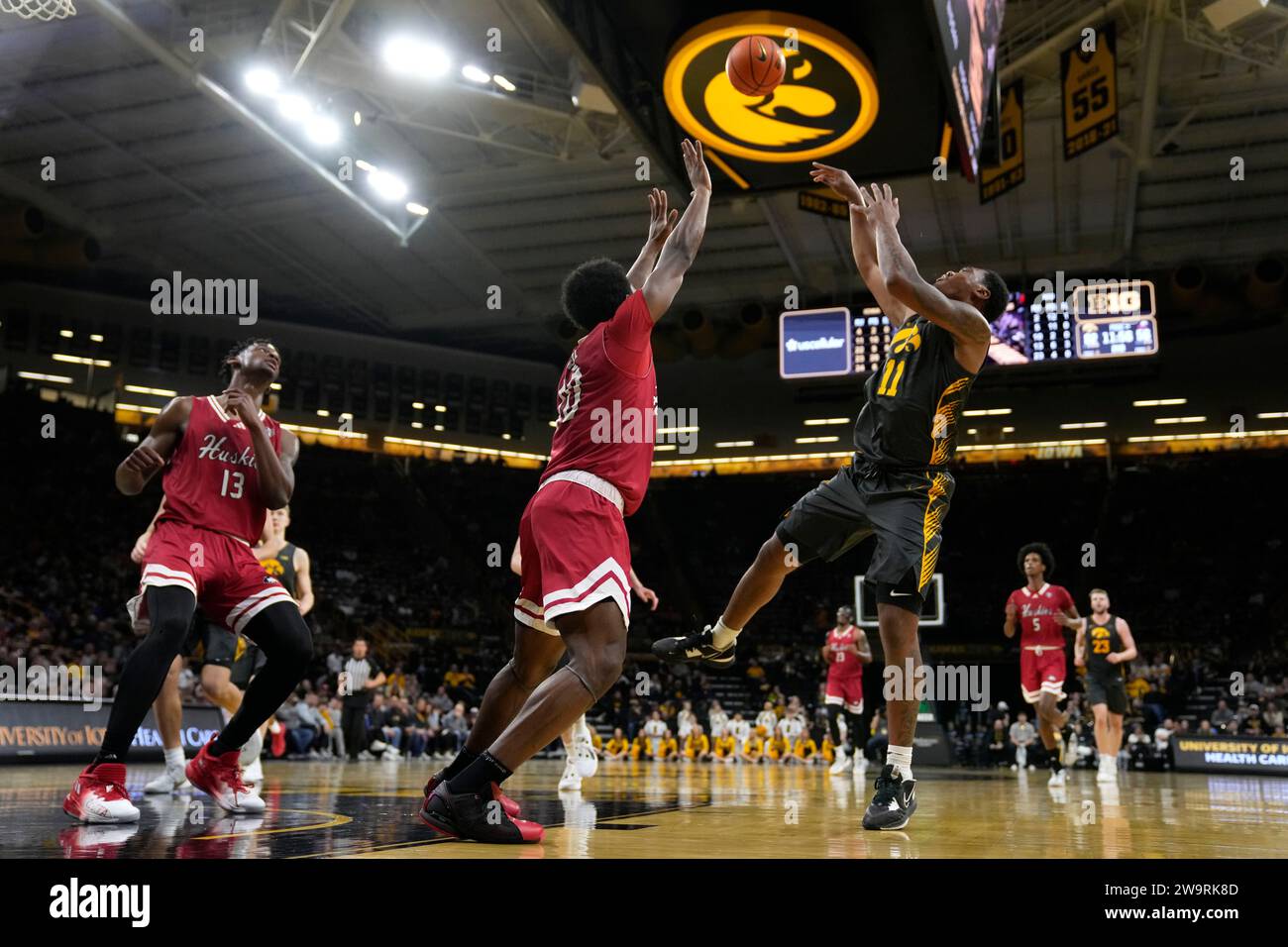 Iowa guard Tony Perkins (11) shoots over Northern Illinois guard Zion ...