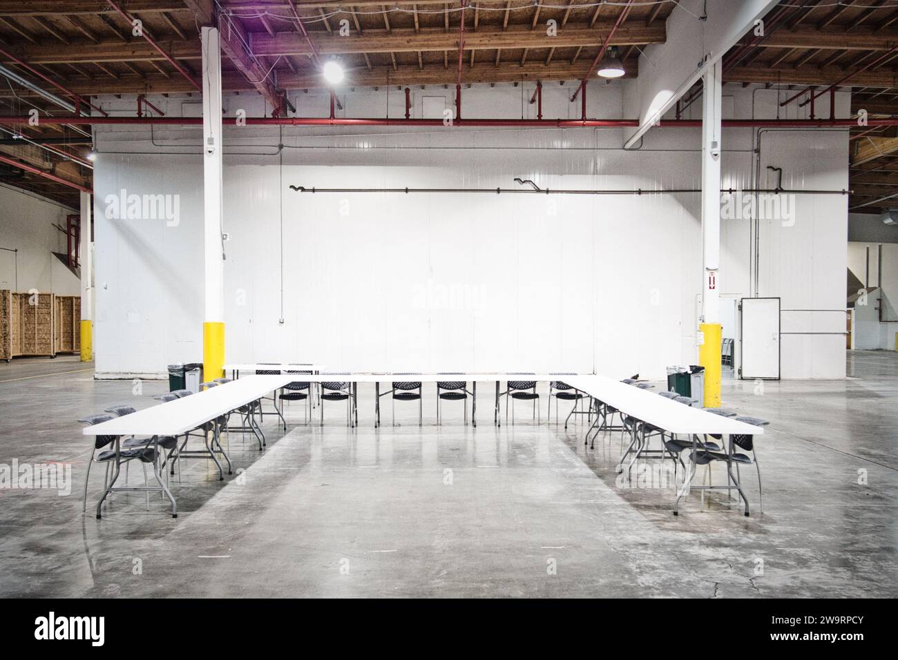 Table and chairs set up as a meeting place in a large industrial ...