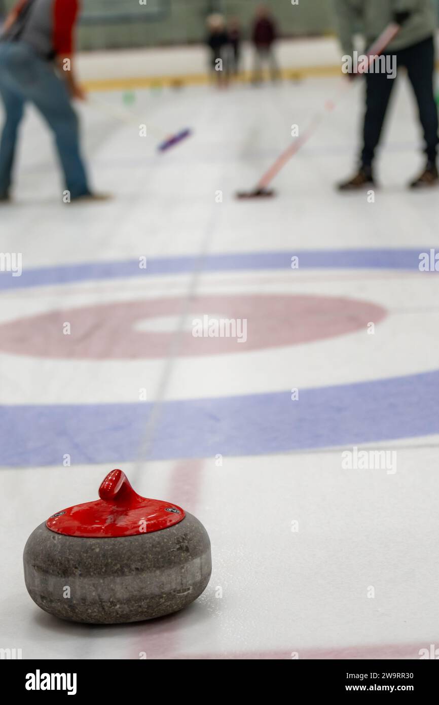 Curling rocks on ice Stock Photo - Alamy