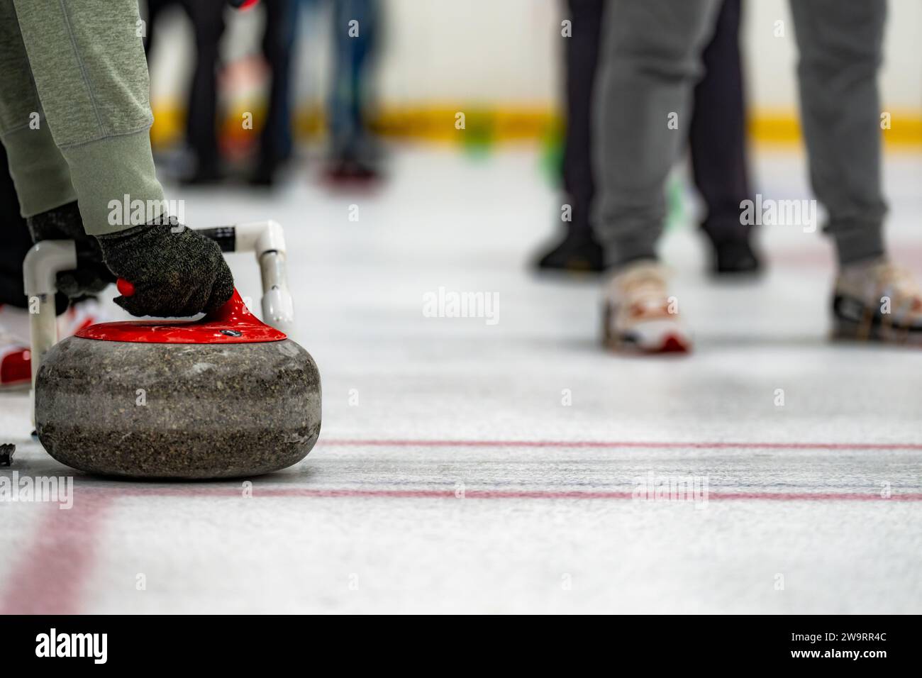 Curling rocks on ice Stock Photo - Alamy