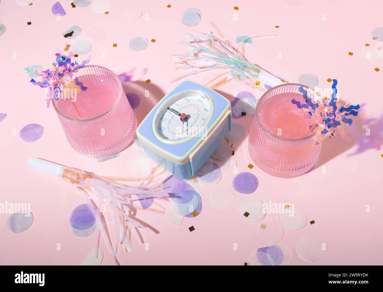 Top View of a Clock Striking Midnight at 12, Two Pink Cocktail ...