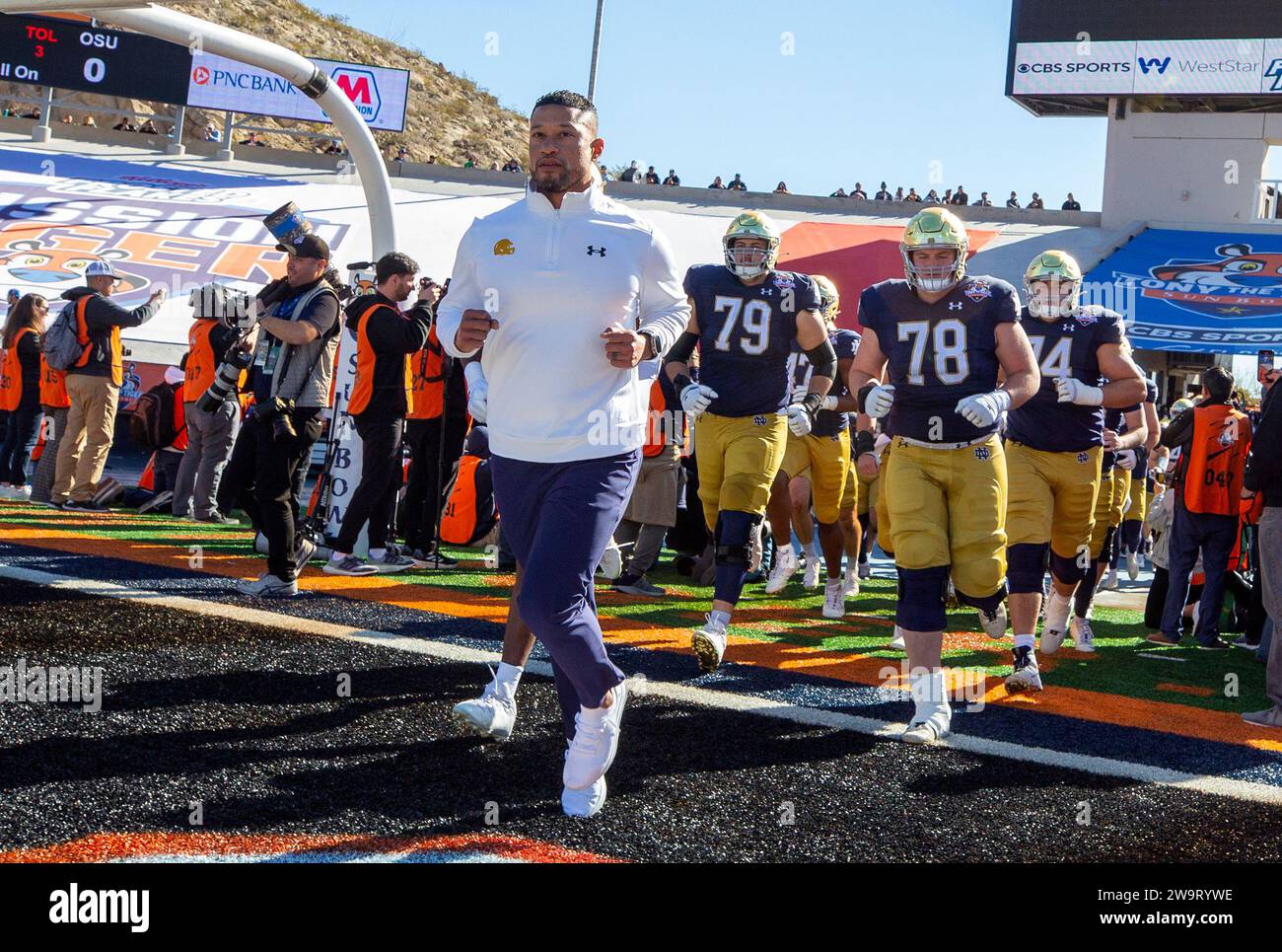Notre Dame coach Marcus Freeman leads his team onto the field to face ...