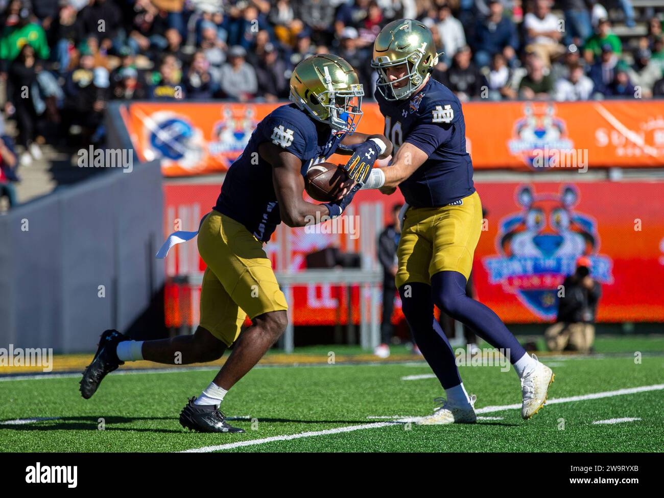 Notre Dame quarterback Steve Angeli (18) hands the ball off to running ...