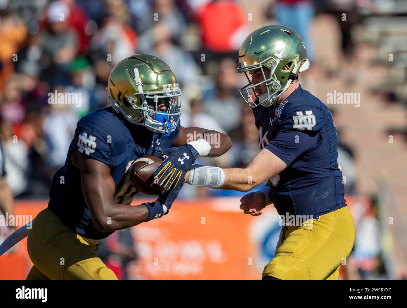 Notre Dame quarterback Steve Angeli (18) hands the ball off to running ...