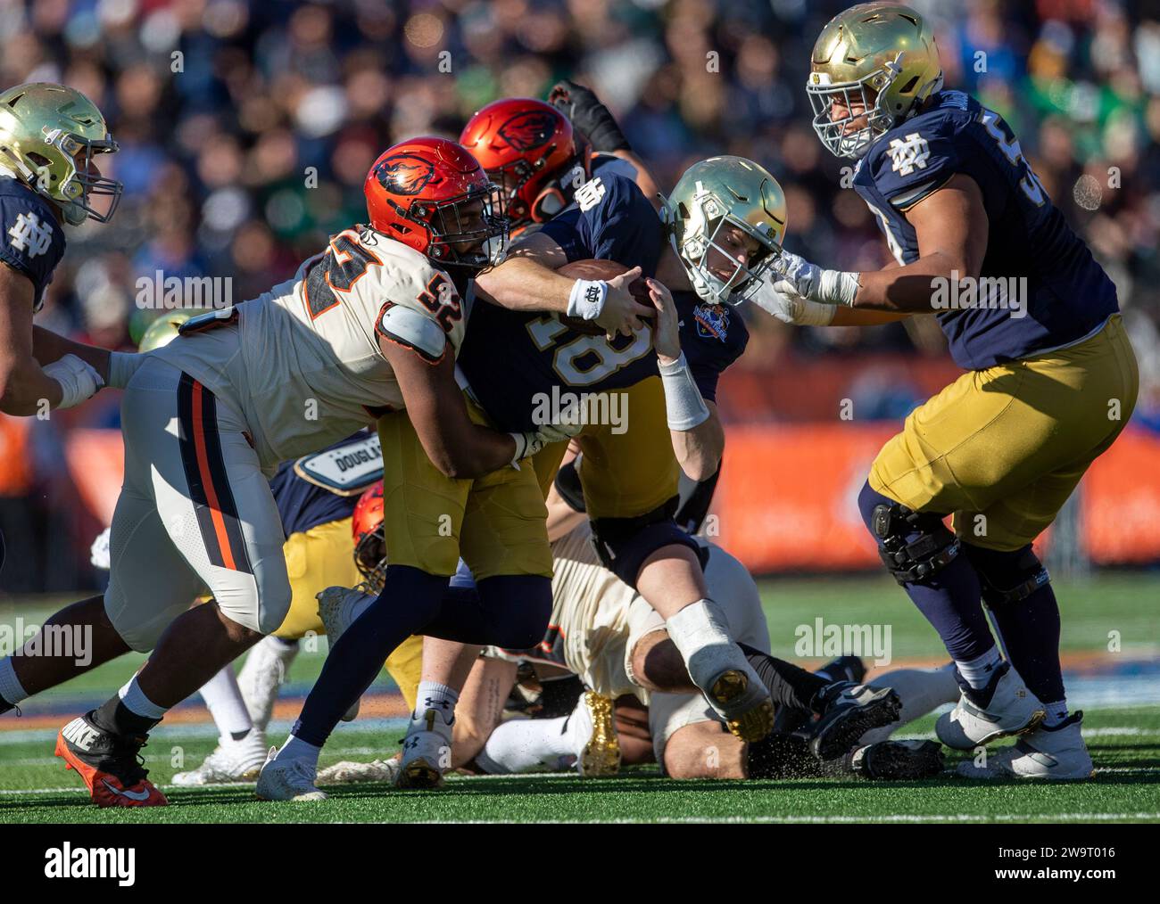Notre Dame quarterback Steve Angeli (18) is tackled by Oregon State ...