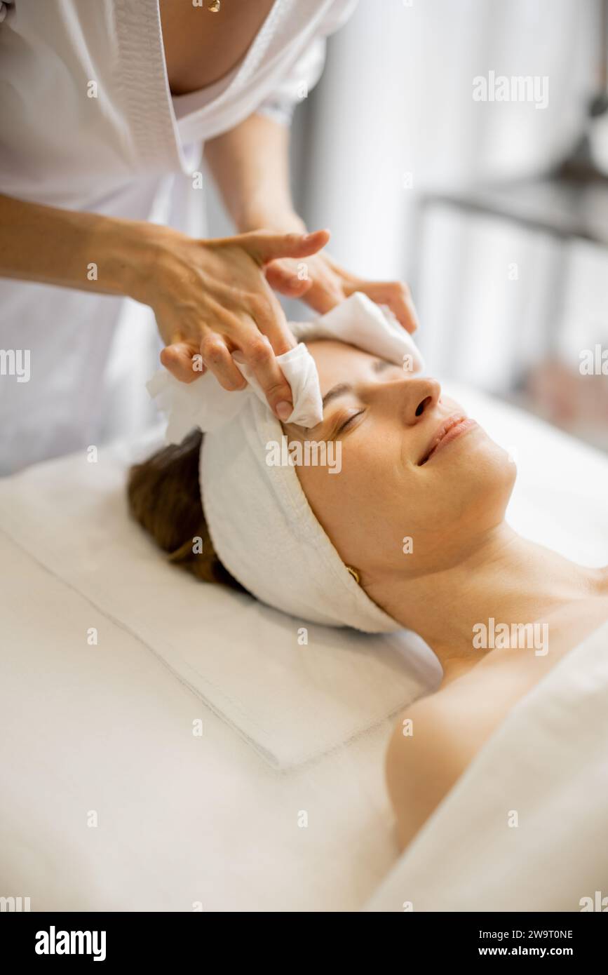 Professional beautician wipes woman face hi-res stock photography and ...
