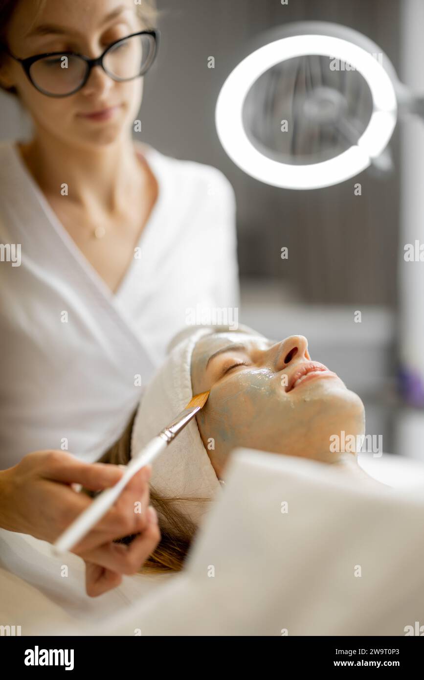Female cosmetologist applies cream hi-res stock photography and images ...