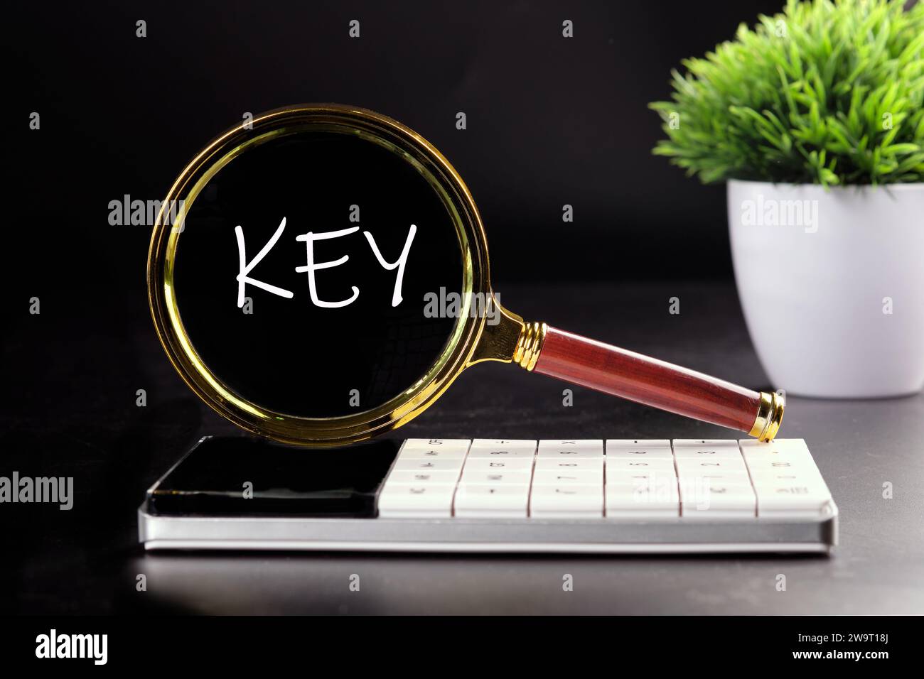 KEY text seen with a magnifying glass on a black background Stock Photo ...