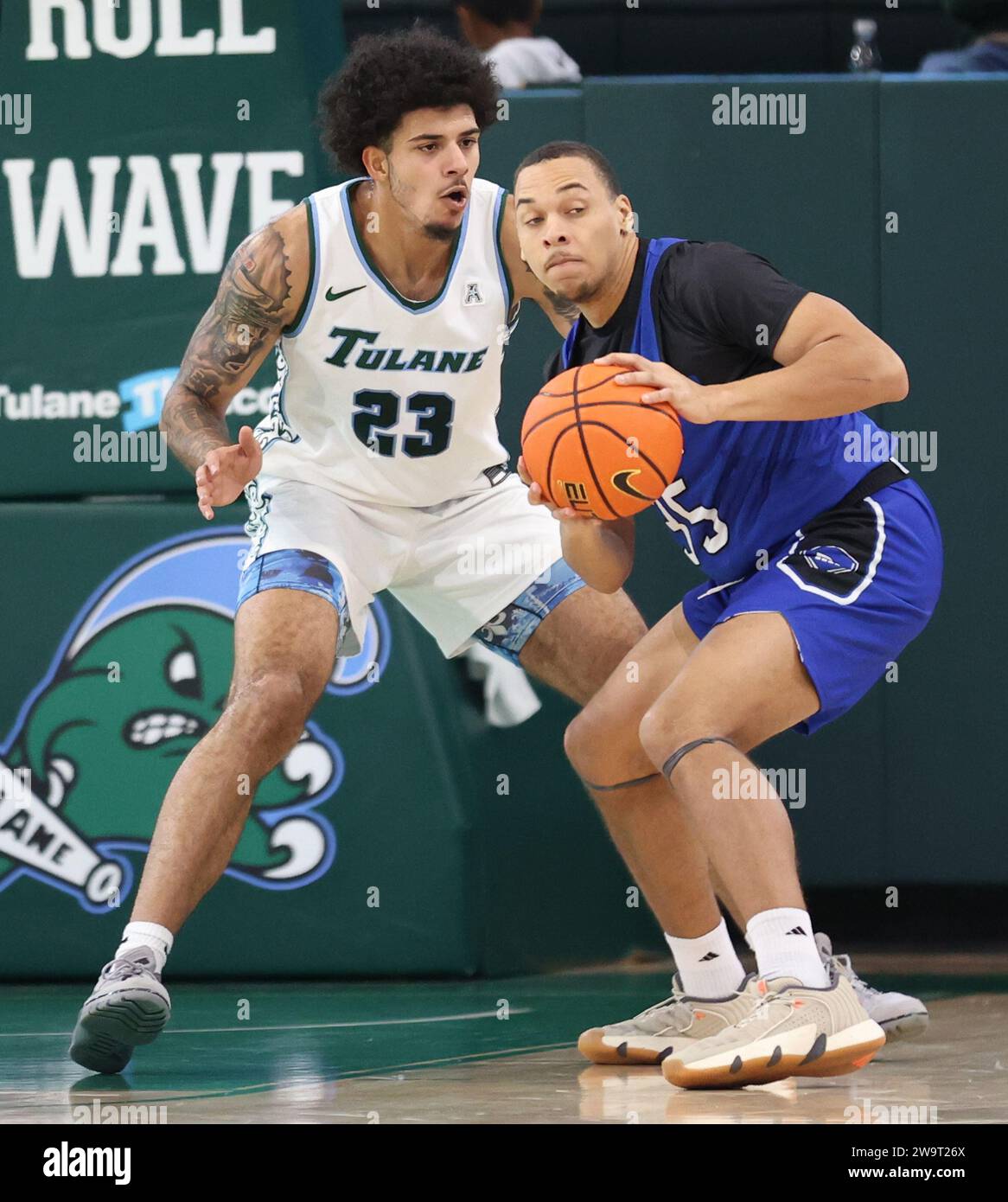 New Orleans, USA. 29th Dec, 2023. Tulane Green Wave center Percy Daniels (23) defends Dillard ...