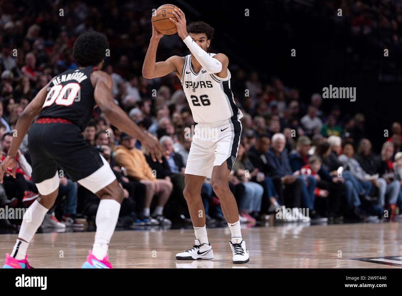San Antonio Spurs forward Dominick Barlow, right, passes the ball ...