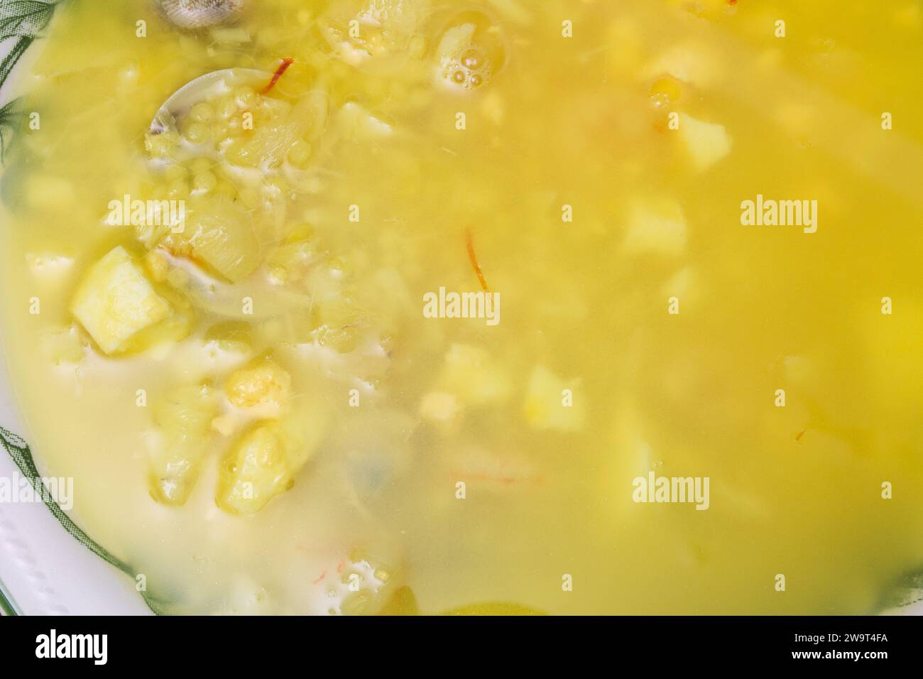 A closeup of a freshly made hot fish and shellfish soup served in an ...