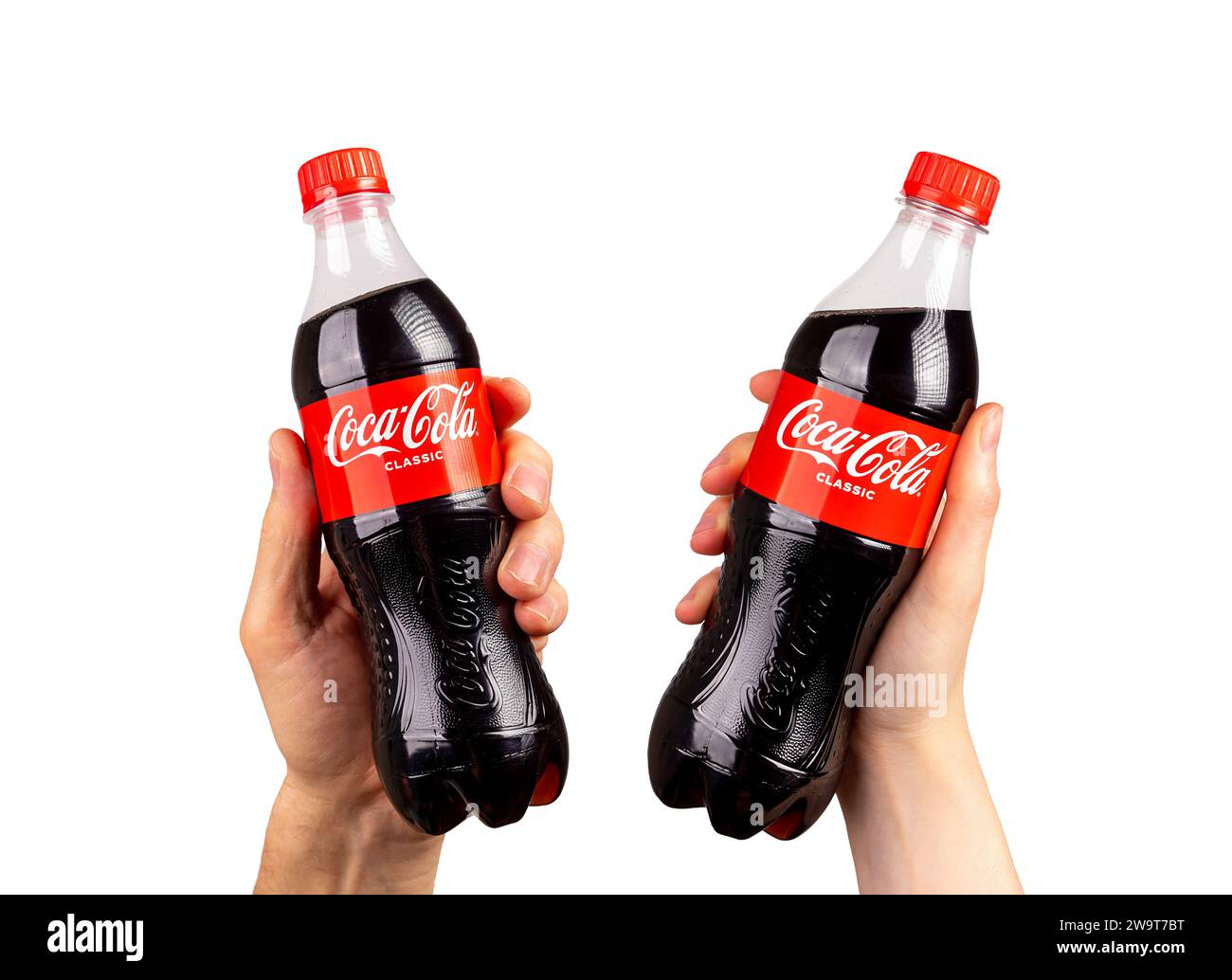 Berlin, Germany December 16 2023 Coca Cola in plastic bottles in hands ...