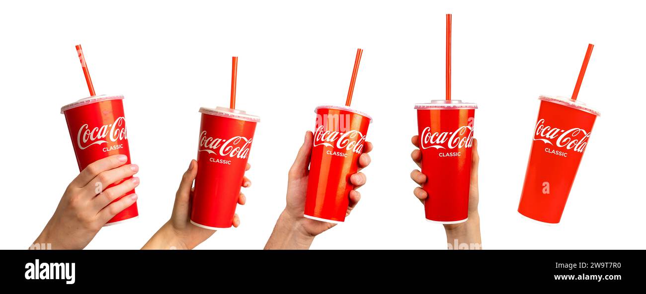 Berlin, Germany December 16 2023 Hands holding Coca Cola set, red paper ...
