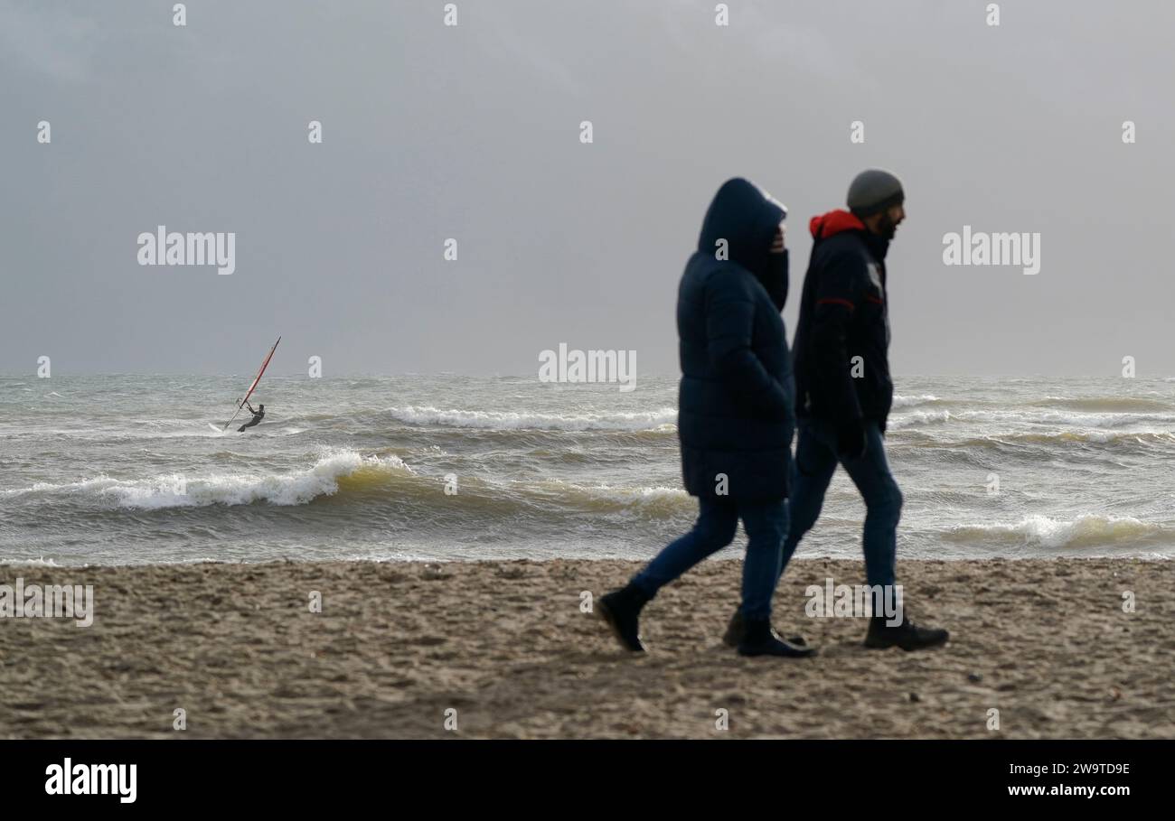 A windsurfer surfs in the sea off of Avon Beach in Dorset. Strong gusts ...