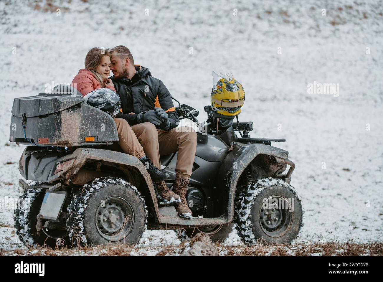 A romantic couple shares a tender embrace and kisses while joyously ...