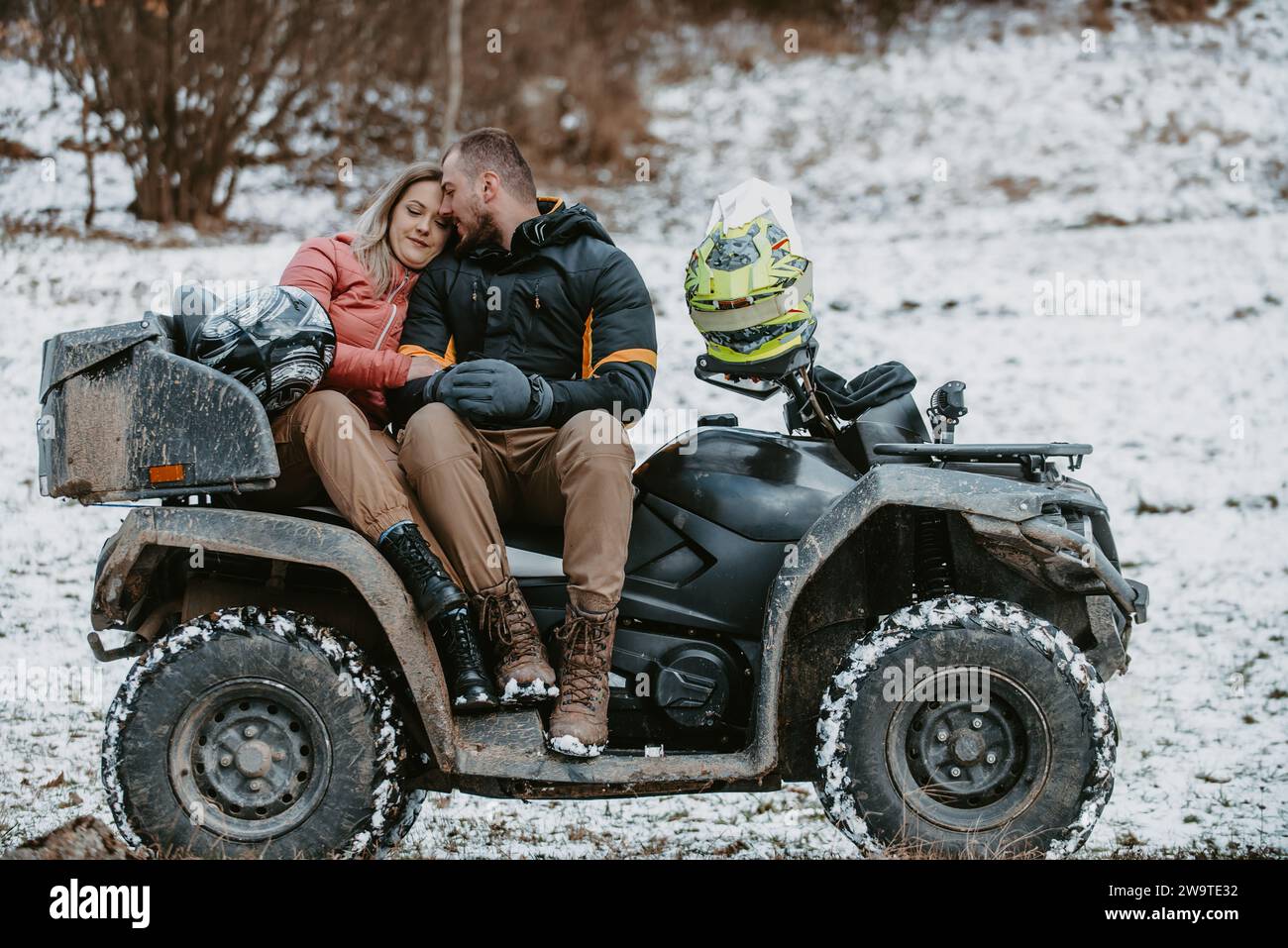 A romantic couple shares a tender embrace and kisses while joyously ...
