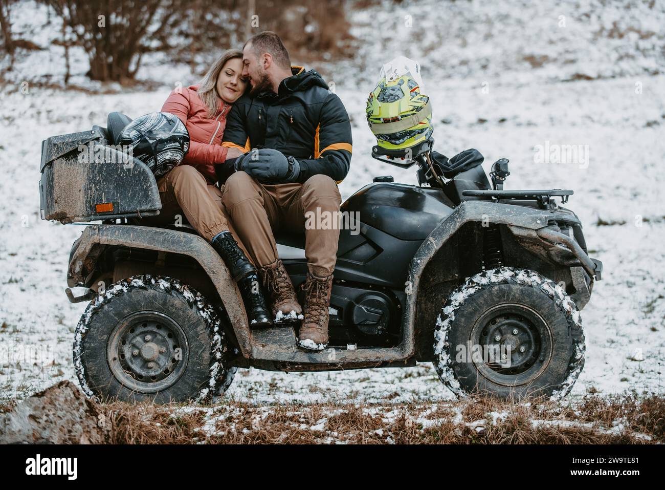 A romantic couple shares a tender embrace and kisses while joyously ...