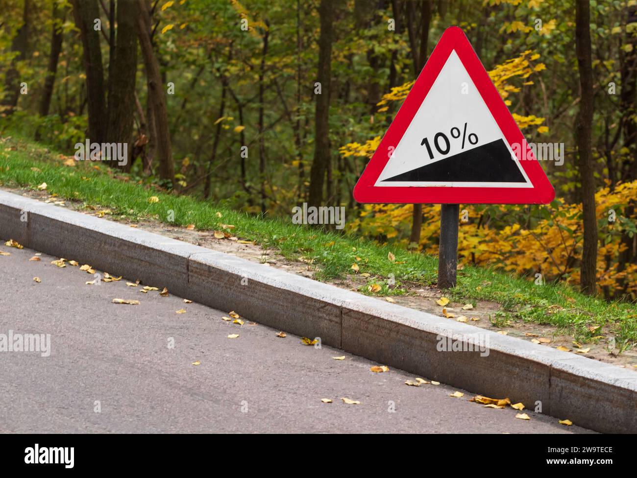 Slope warning road sign. Road safety Stock Photo - Alamy