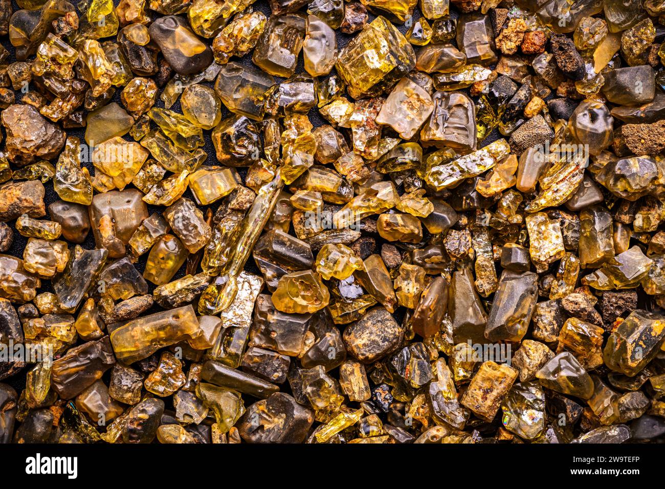 yellow olivine stone chips macro detail texture background. close-up ...