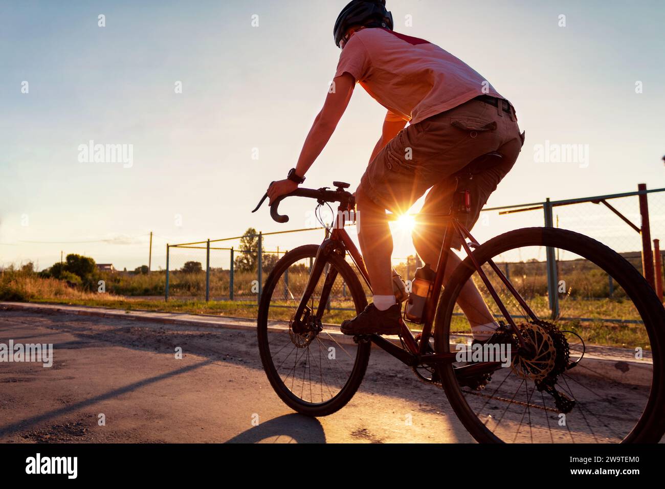 The cyclist rides on his bike at sunset with sunbeam. Sport. Active ...