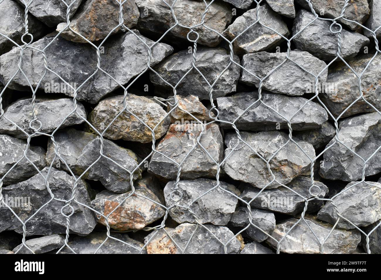Mesh rock wall to prevent landslides on a slope Stock Photo - Alamy