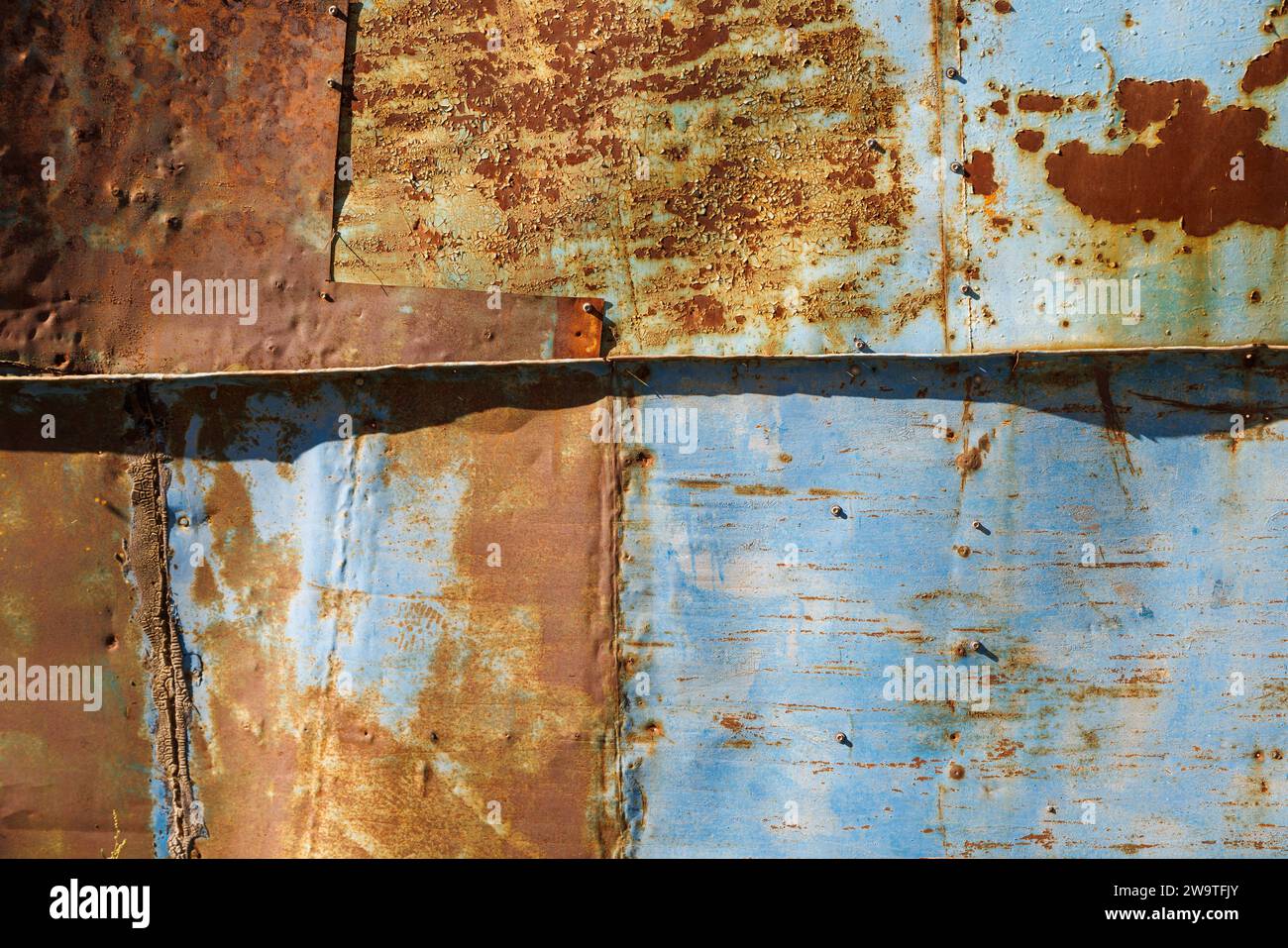 rusted steel sheets with leftovers of peeling blue paint closeup ...