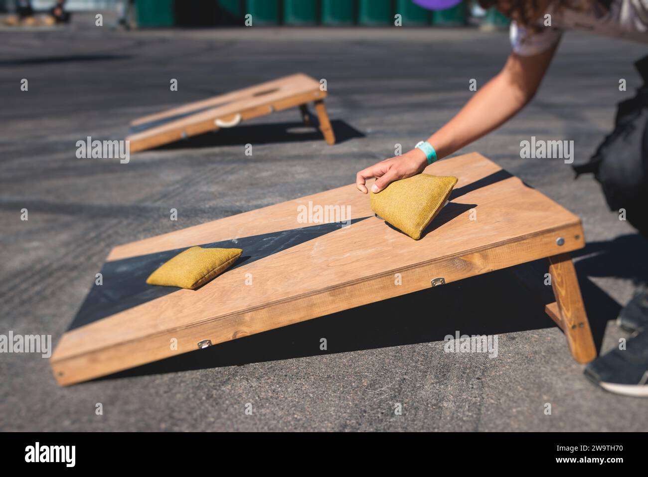 Cornhole game set, process of throwing bean bags, kids children tossing ...