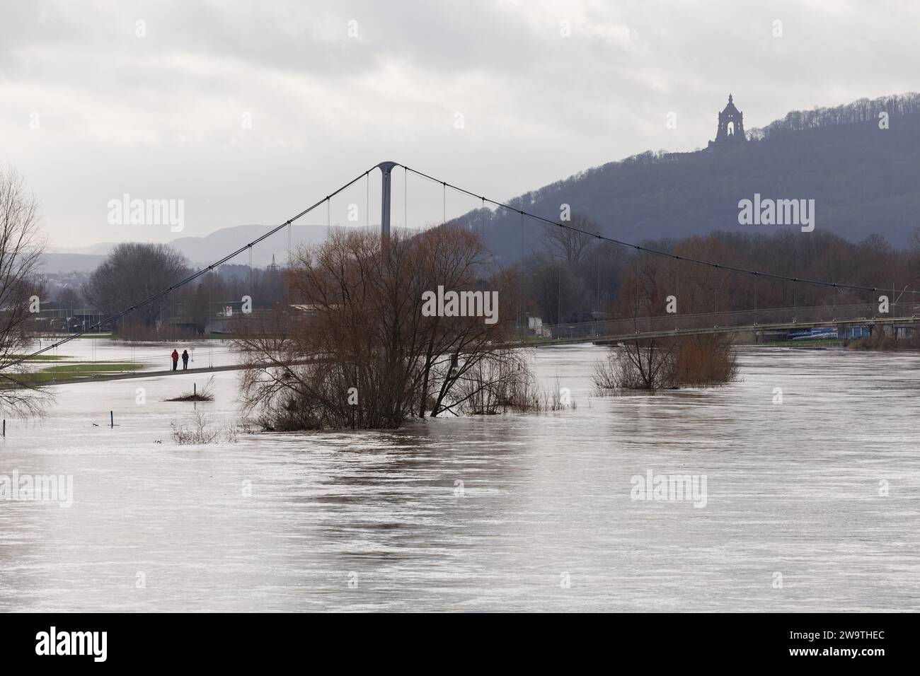 Minden, Germany. 30th Dec, 2023. View of a bridge over the river Weser, which is in flood. The ...